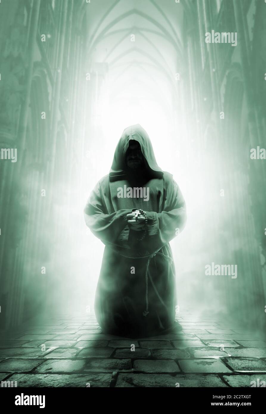 Mystery medieval monk praying on kneels in dark temple corridor Stock ...