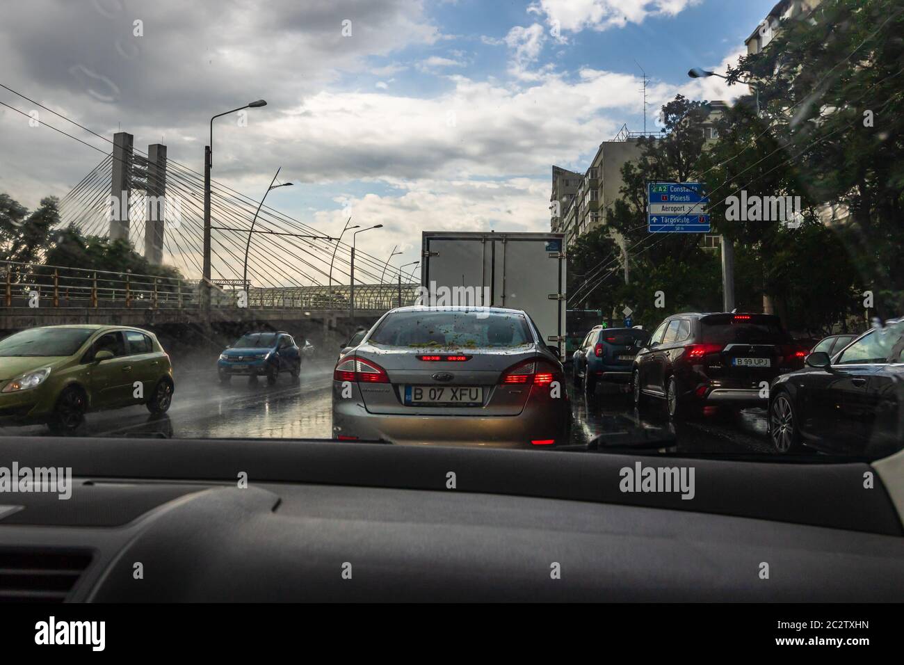 Traffic in rainy day with road view through car window with rain drops ...