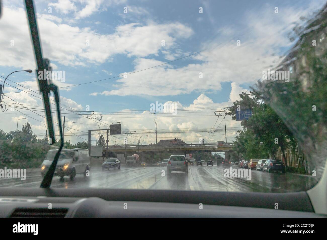 Traffic in rainy day with road view through car window with rain drops ...
