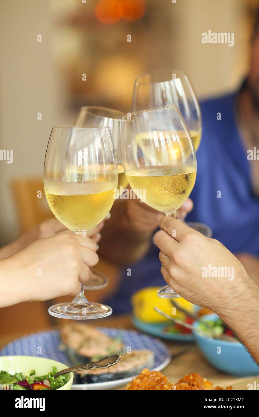 Hands of a group of people cheering with white wine Stock Photo - Alamy
