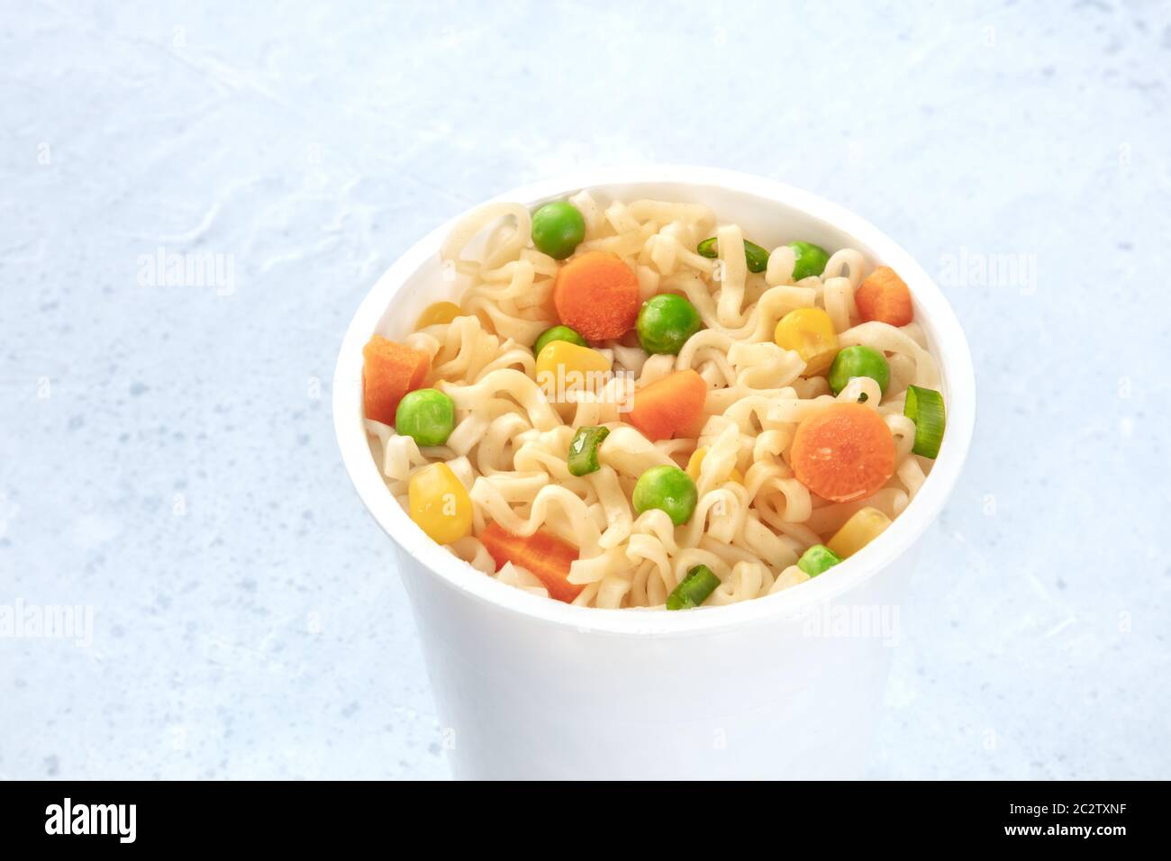 Ramen cup close-up, instant soba noodles in a plastic cup with green ...