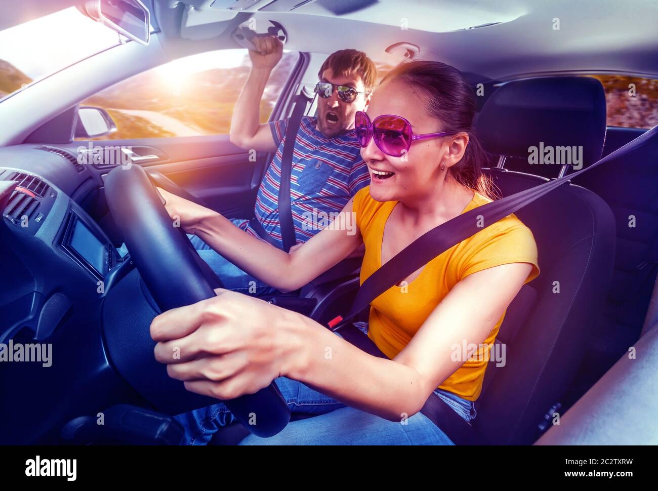 Couple travelling by car, woman driving, man is scared Stock Photo - Alamy