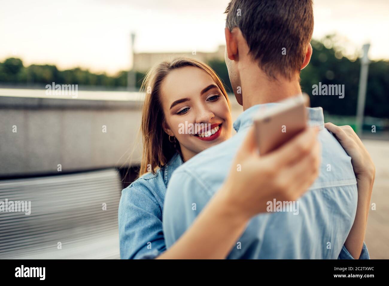 Phone addiction, addict couple hugs and using gadgets, social addicted ...
