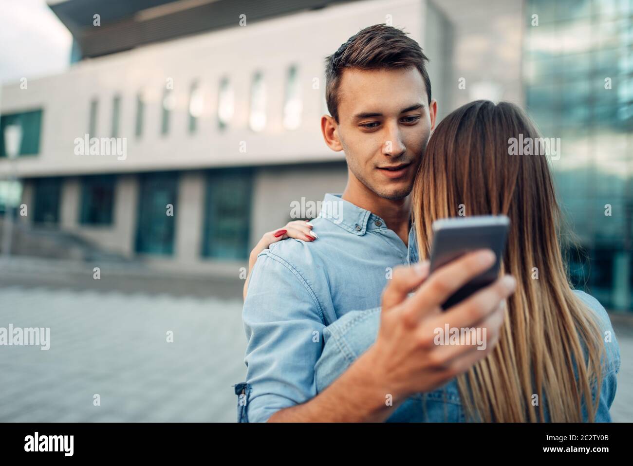 Phone addiction, addict man hugs his woman and using gadget at this ...
