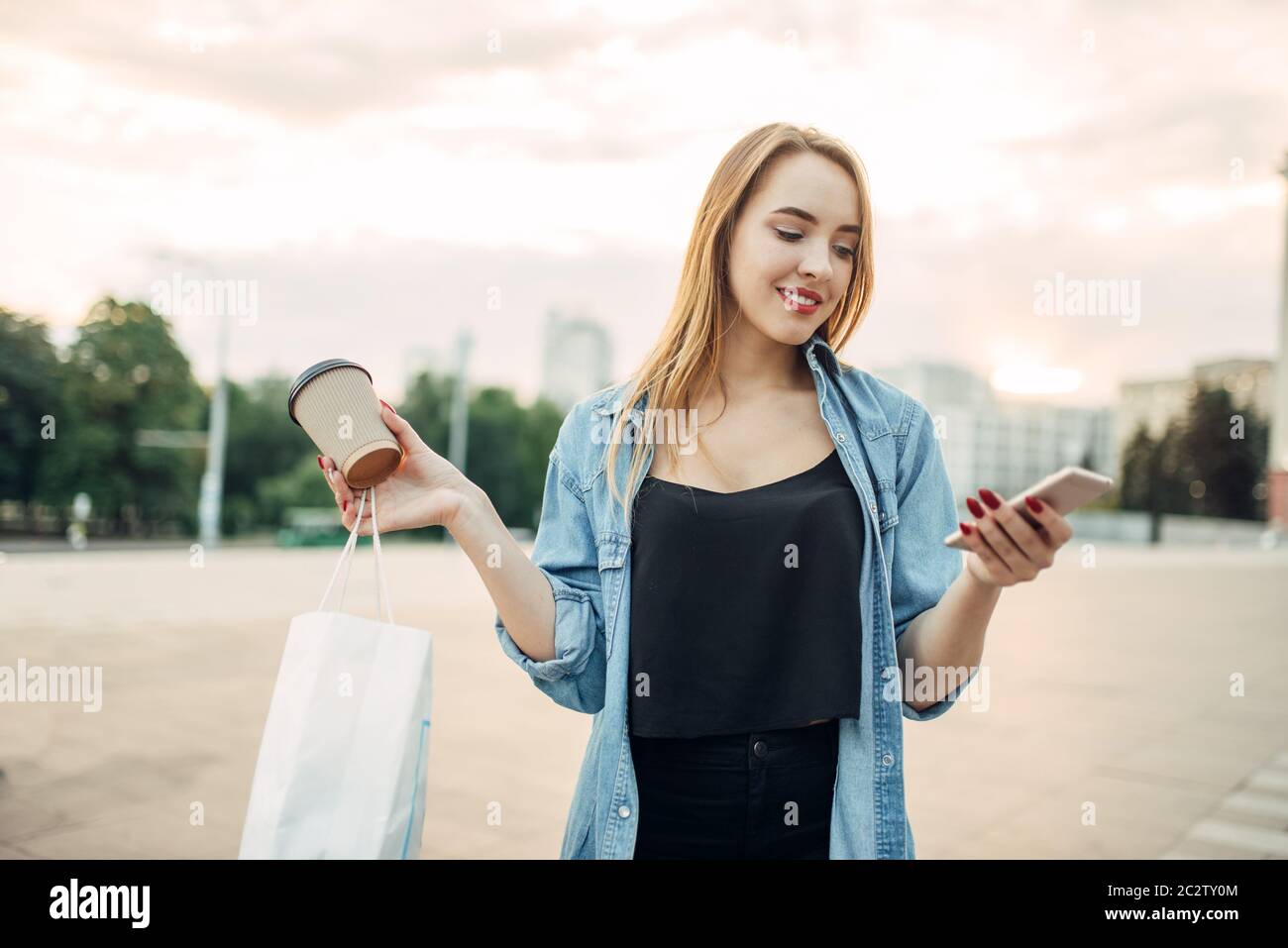 Phone addiction, addict woman holds gadget and coffee in hands, social ...