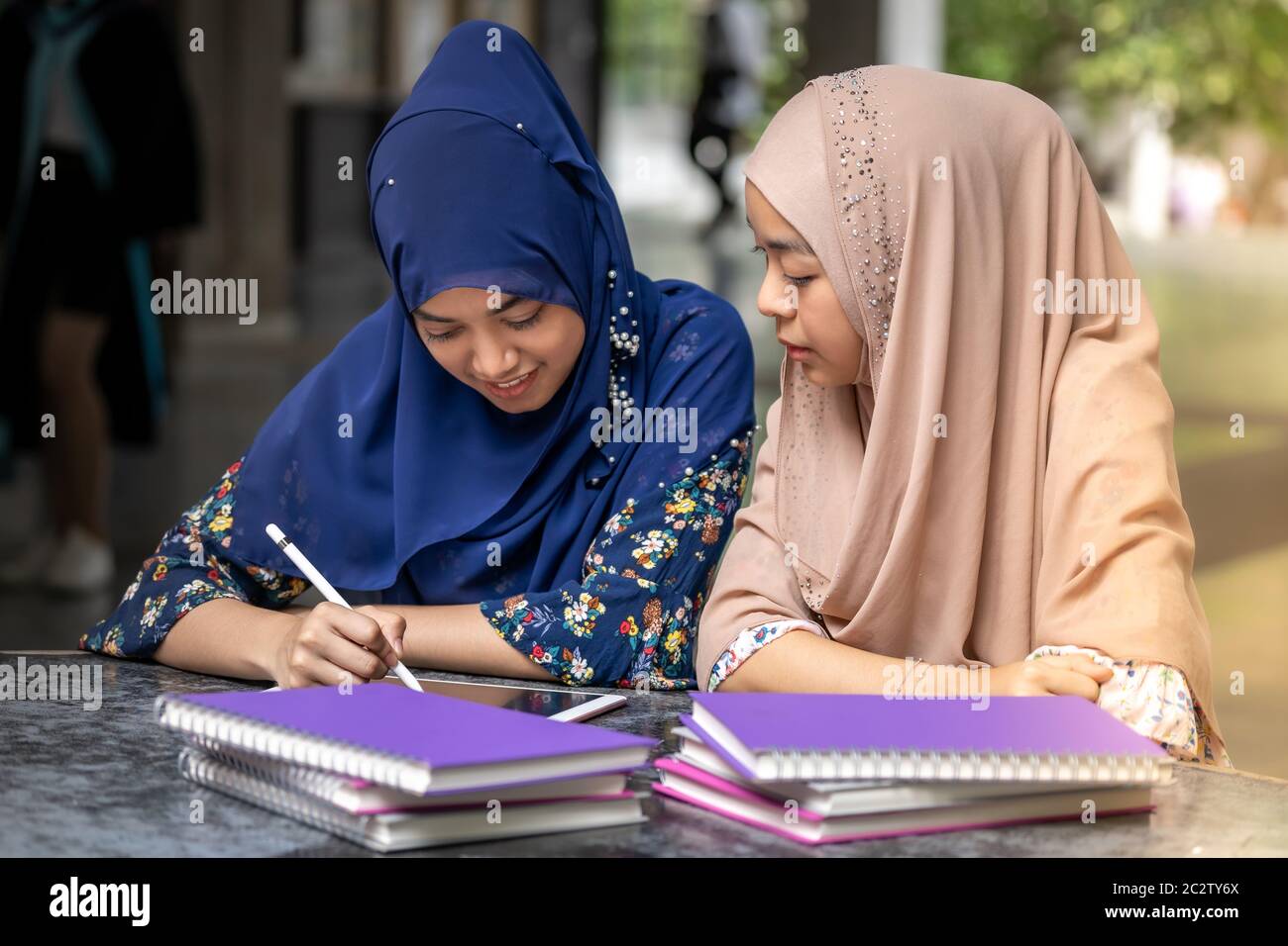 Muslim Student reading book Stock Photo - Alamy