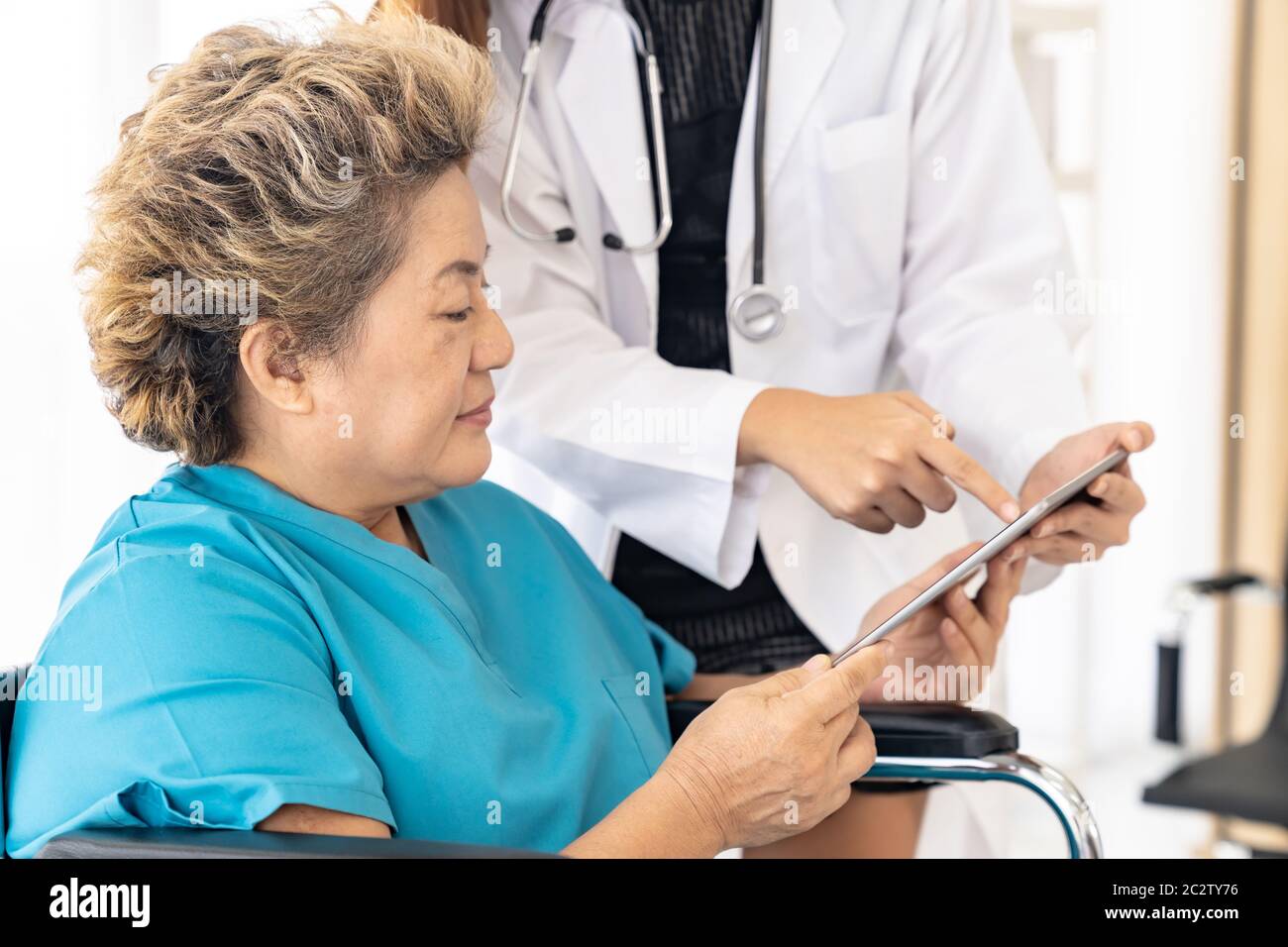 Doctor using tablet talking examination hi-res stock photography and ...