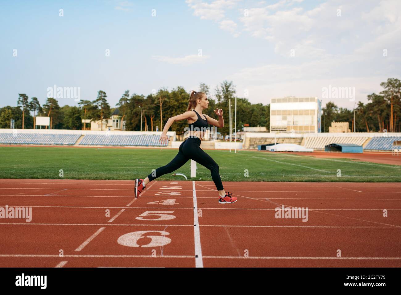 Female runner in sportswear crosses the finish line, training on ...