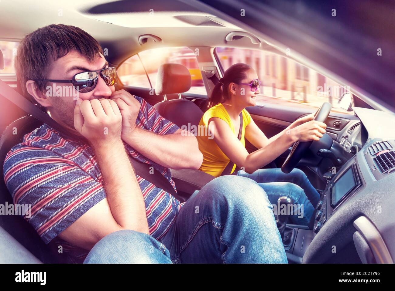 Couple travelling by car, woman is driving, man is very scared Stock ...