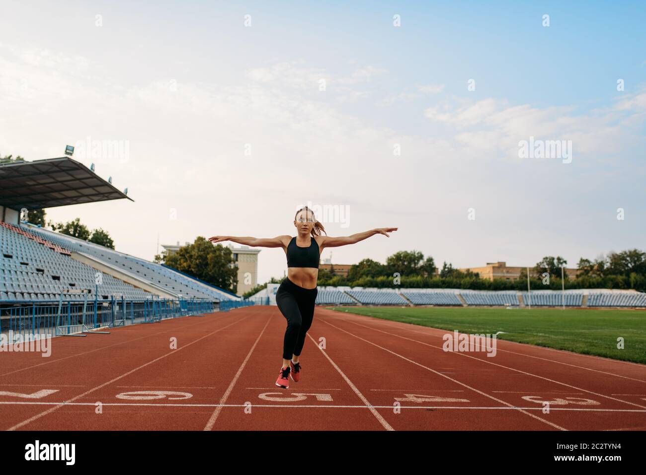 Female jogger in sportswear crosses the finish line, training on ...