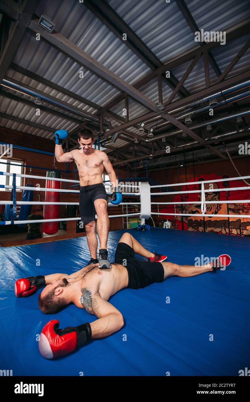 Fighter wins the strike on the ring. Boxing ring on the background ...