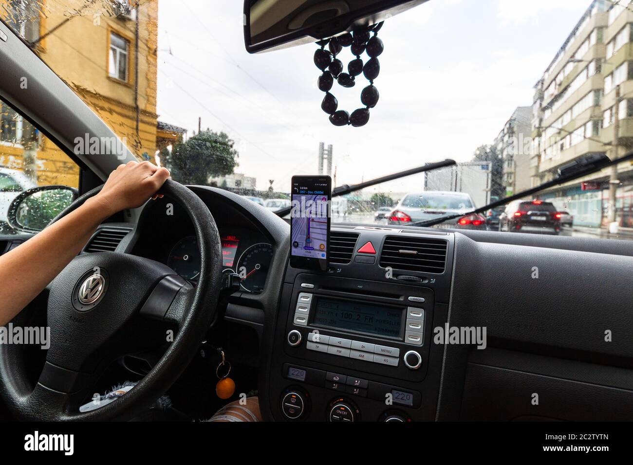 Using waze maps application on smartphone on car dashboard, Driver ...