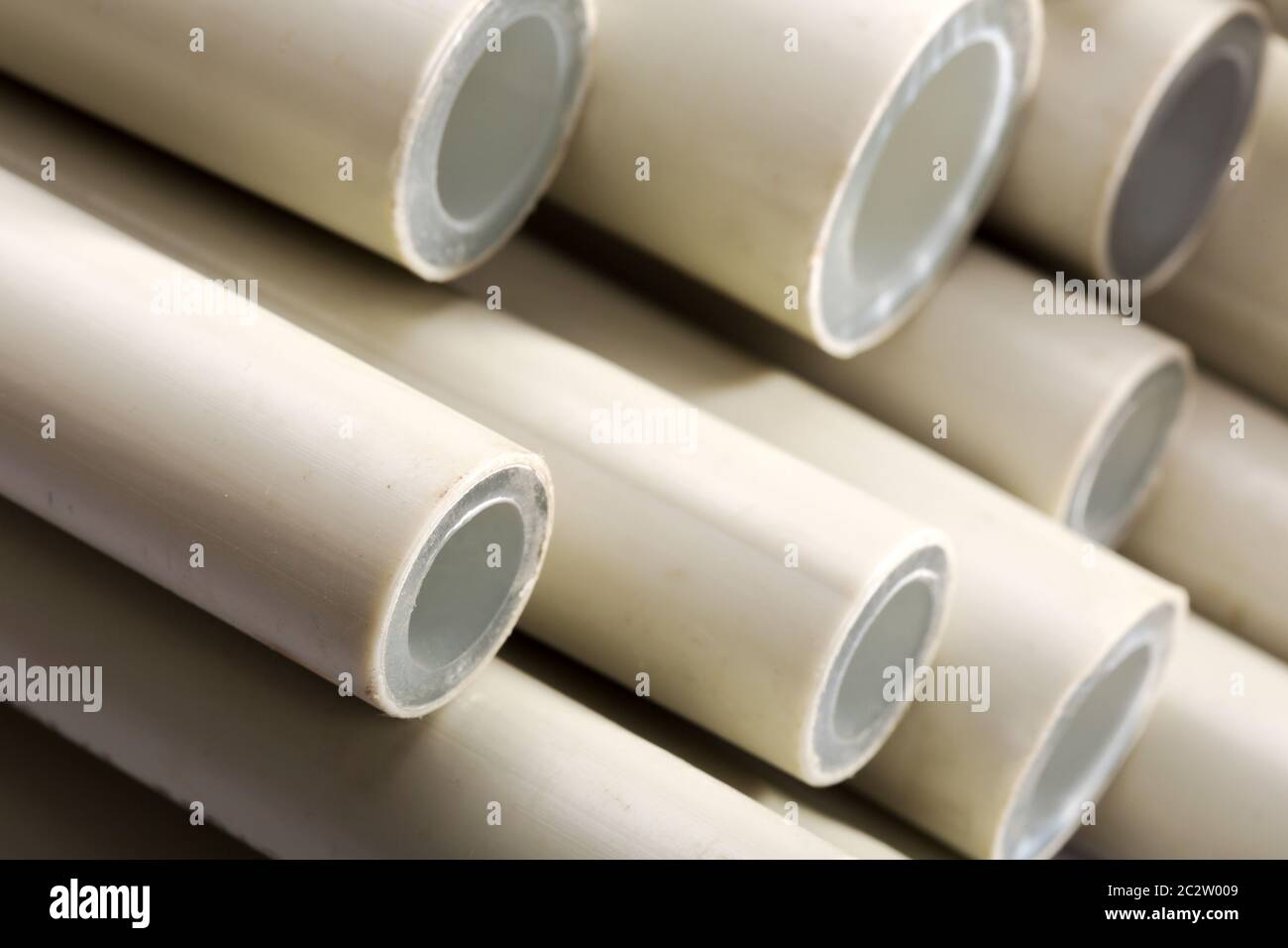 Closeup of plastic pipes pile Stock Photo - Alamy