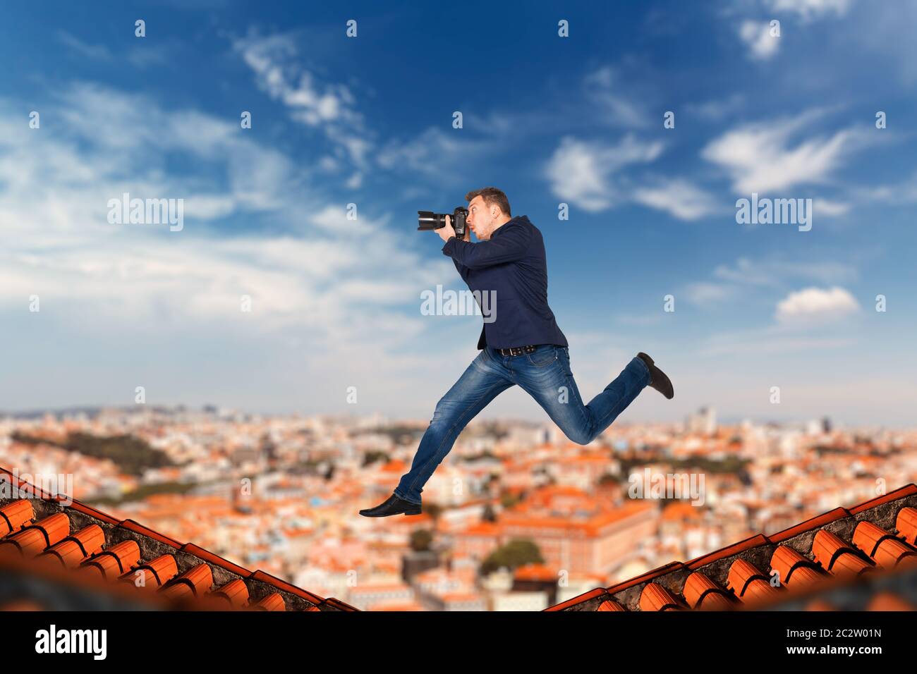 Professional male photographer with digital camera takes pictures ...