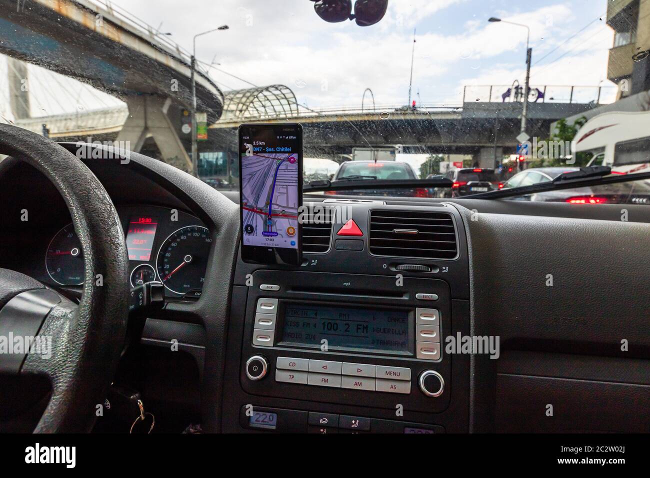 Using waze maps application on smartphone on car dashboard, Driver ...