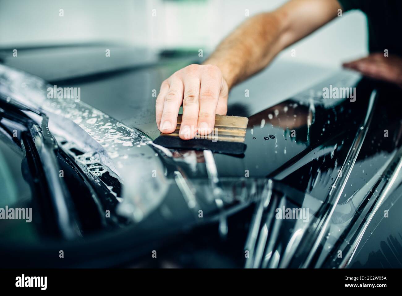 Auto paint protection, transparent film closeup. Car protect against ...