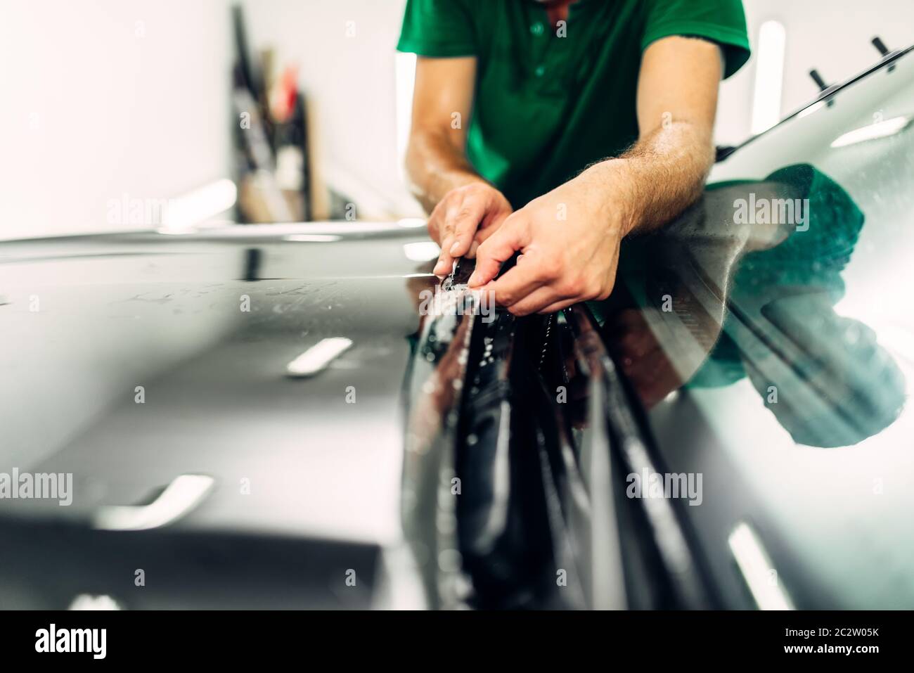 Professional worker install paint protect. Transparent protection film ...