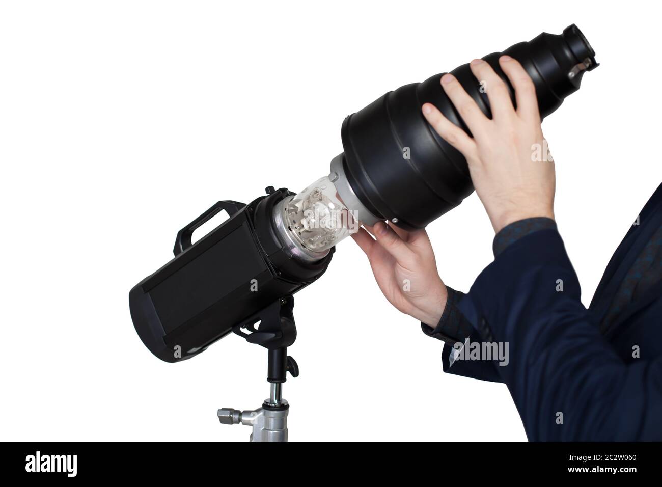 Professional photographer hands adjusts the lighting in photo studio ...