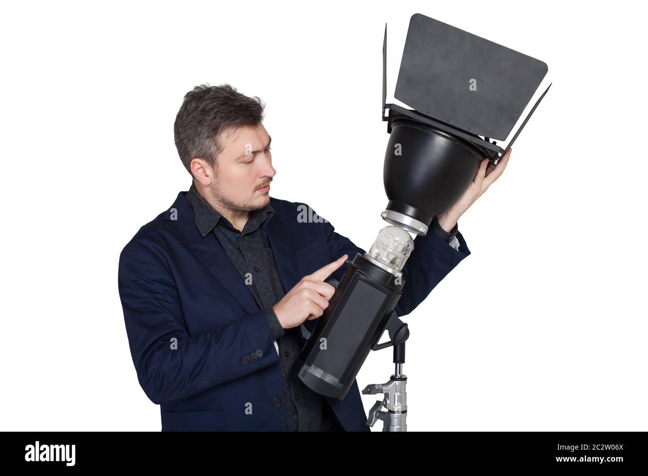 Professional photographer sets lighting lamp, white background ...