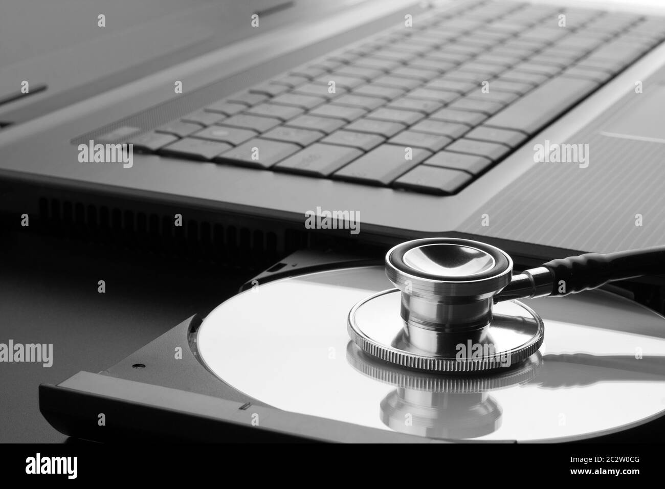 Medical stethoscope examining CD - DVD for viruses Stock Photo - Alamy