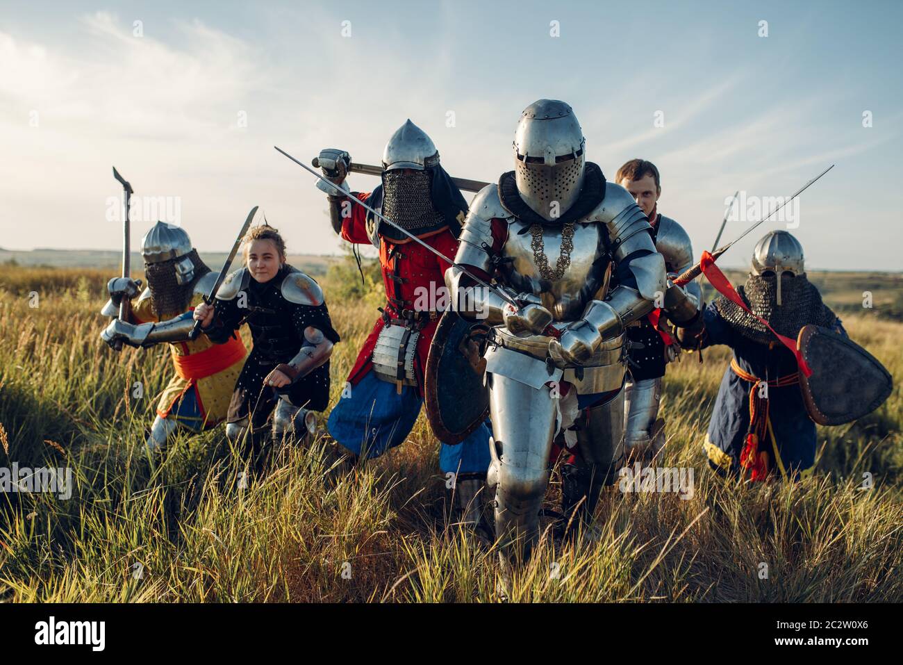 Medieval knights in armor and helmets fight with sword and axe, great ...