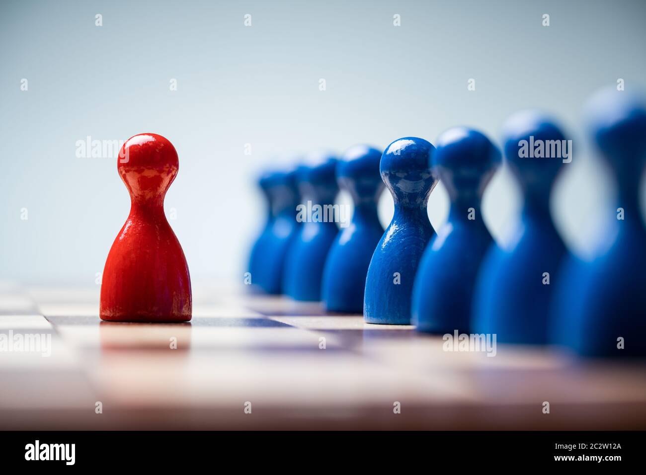 Red Pawns In Front Of Blue Pawns On Chessboard Against Blue Background ...