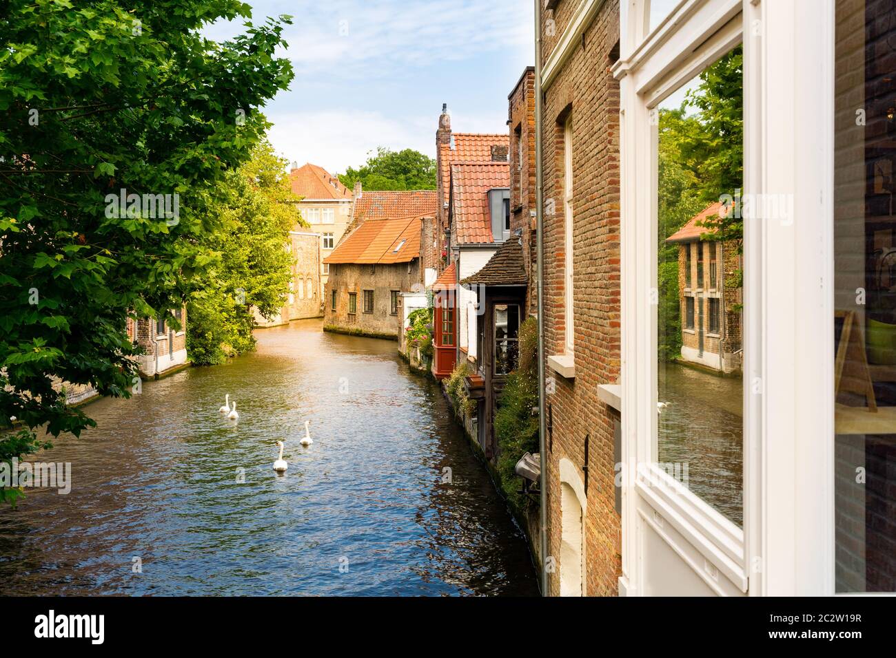 Ancient building facades on river canal in old tourist town, Europe ...