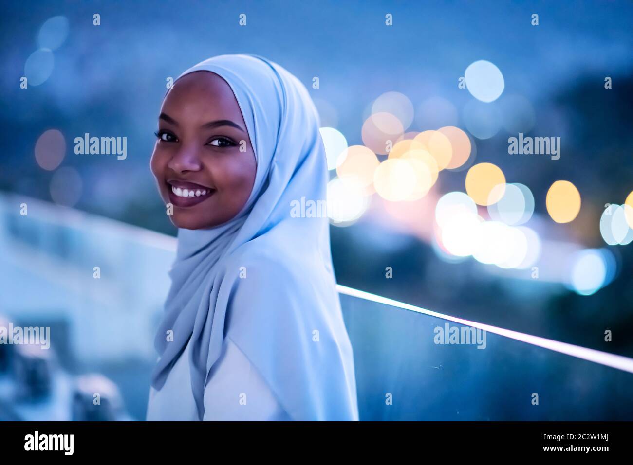 African modern Muslim woman in night at balcony Stock Photo - Alamy