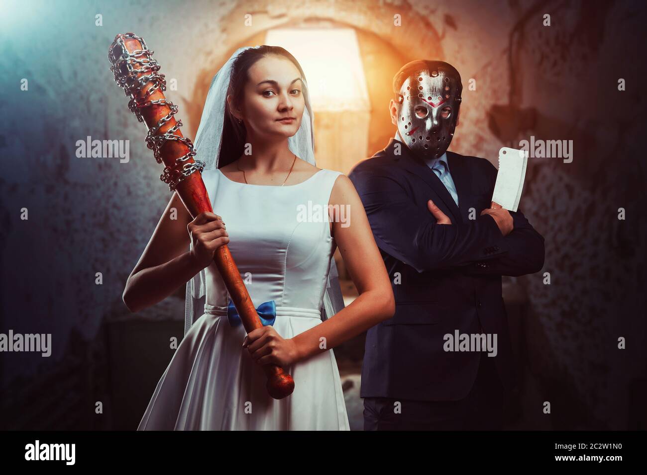 Newlyweds maniacs, an interior of old prison on background. Couple with ...