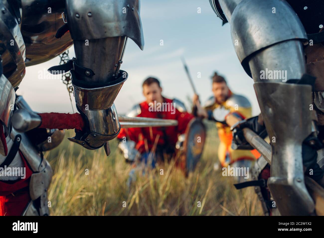 Medieval knights in armor standing opposite each other before battle ...