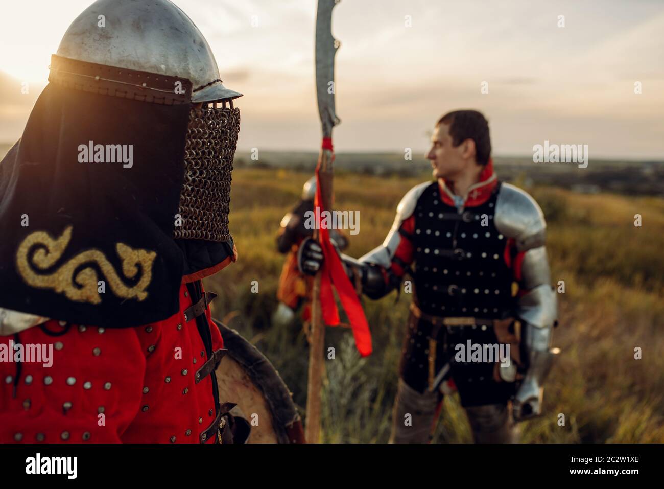 Medieval knights in armor and helmet at sunset, great tournament ...