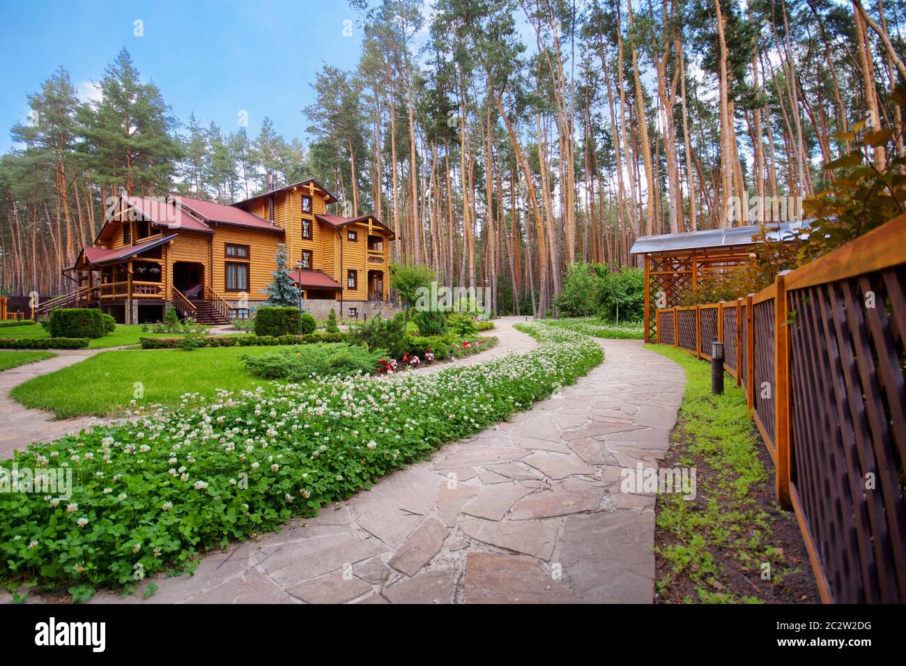 Big wooden mansion in pine forest Stock Photo - Alamy