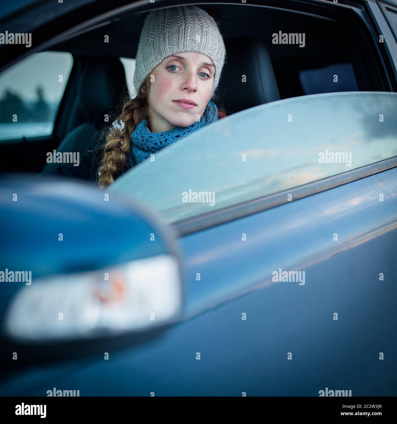 Woman driving a car - female driver at a wheel of a modern car, looking ...