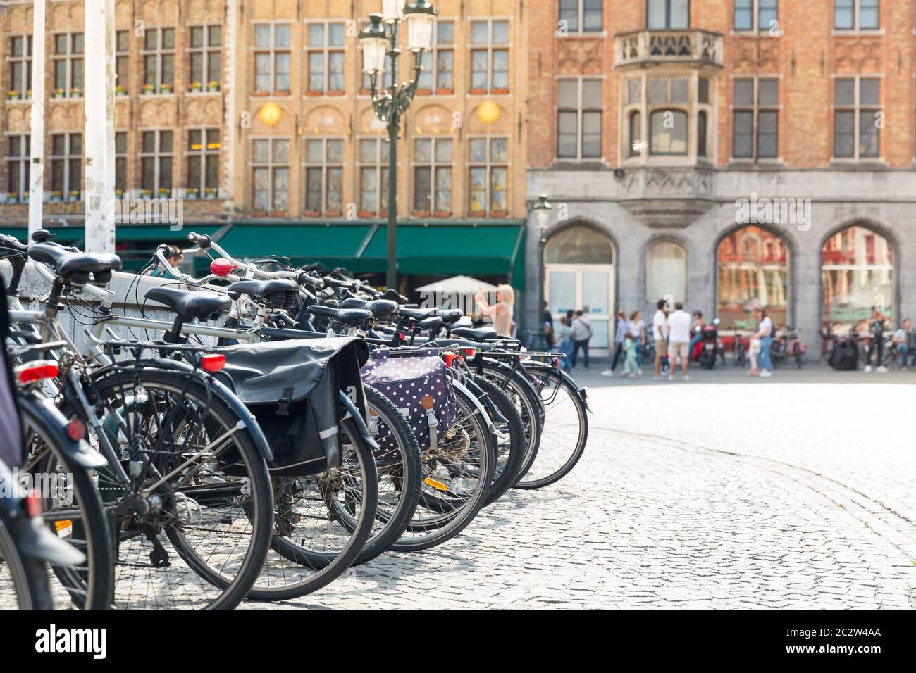 Bycicles on the square, people in street cafe on background, old ...