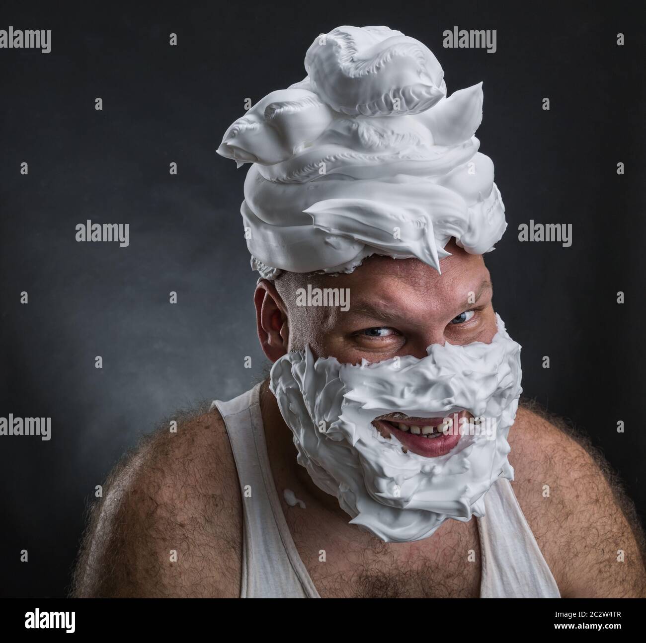 Strange smiling man with shaving foam on his face and on his head over ...