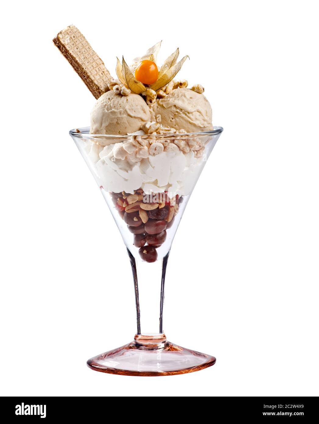 Big ice cream dessert with fruit and whipped cream on a white ...