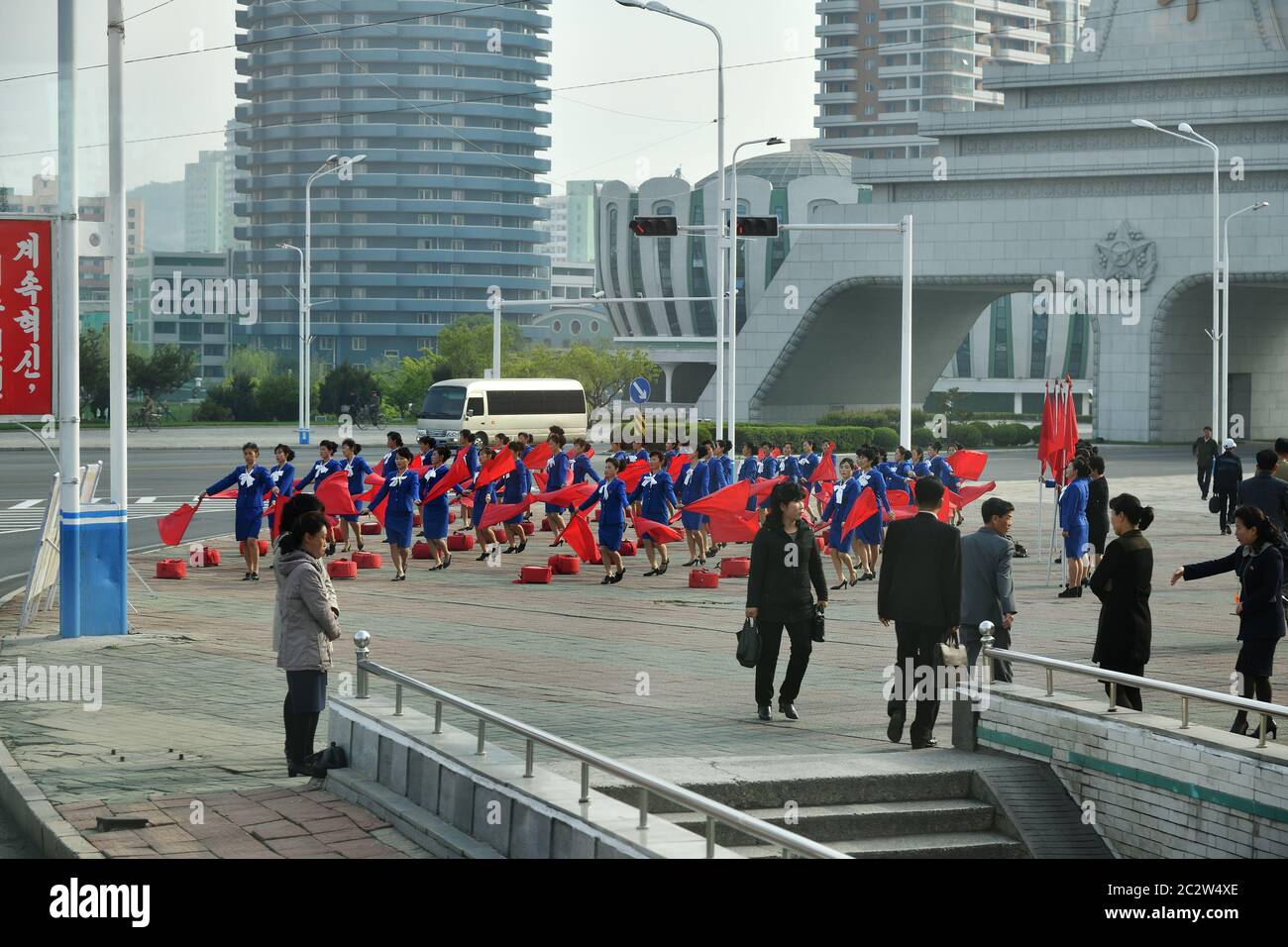 Pyongyang, North Korea - April 30, 2019: Girls with red flags perform ...