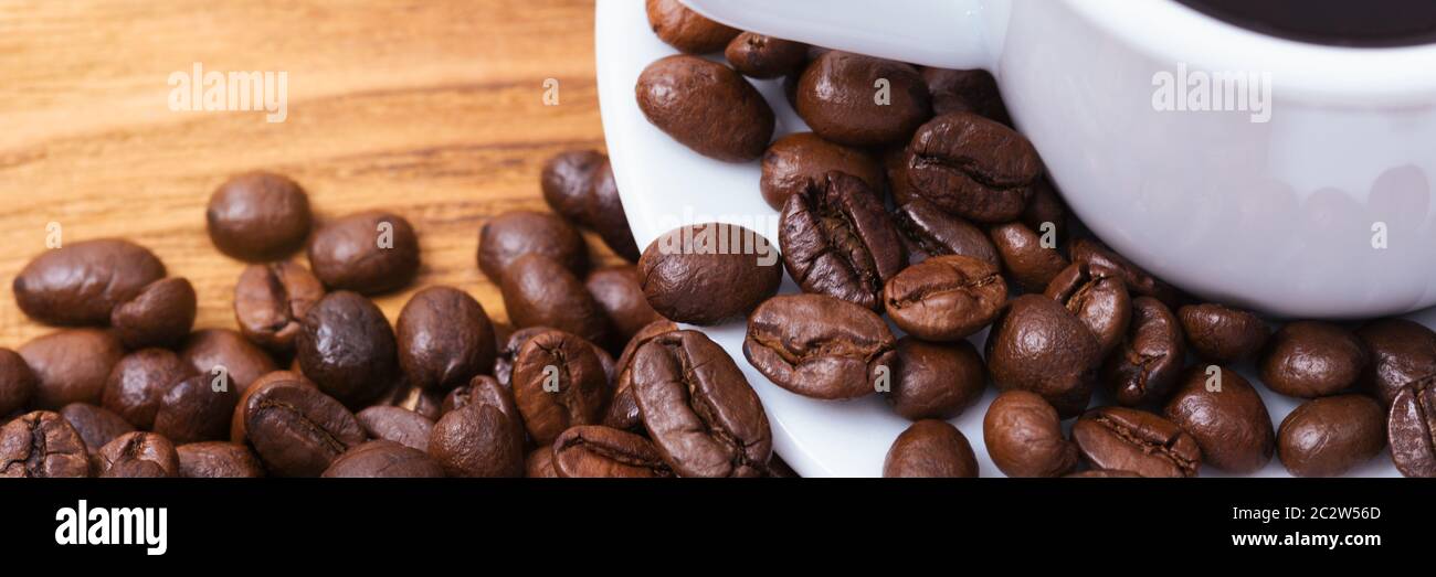 Coffee bean. On the background of wooden boards a cup of coffee and ...