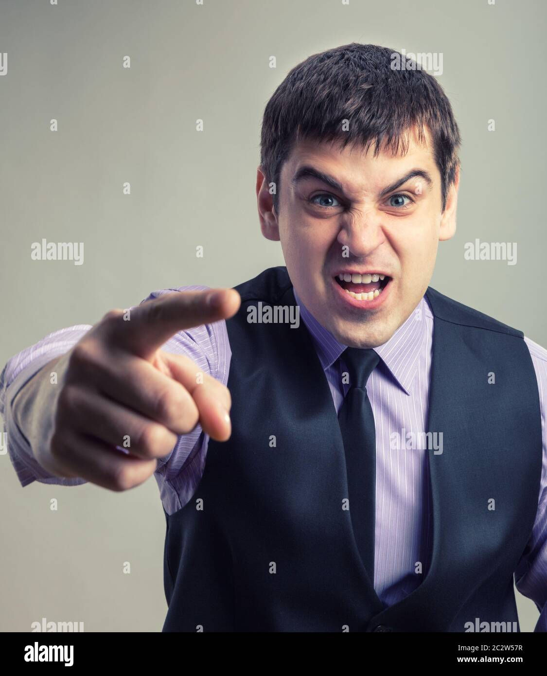 Angry businessman pointing at you. Toned colors Stock Photo - Alamy