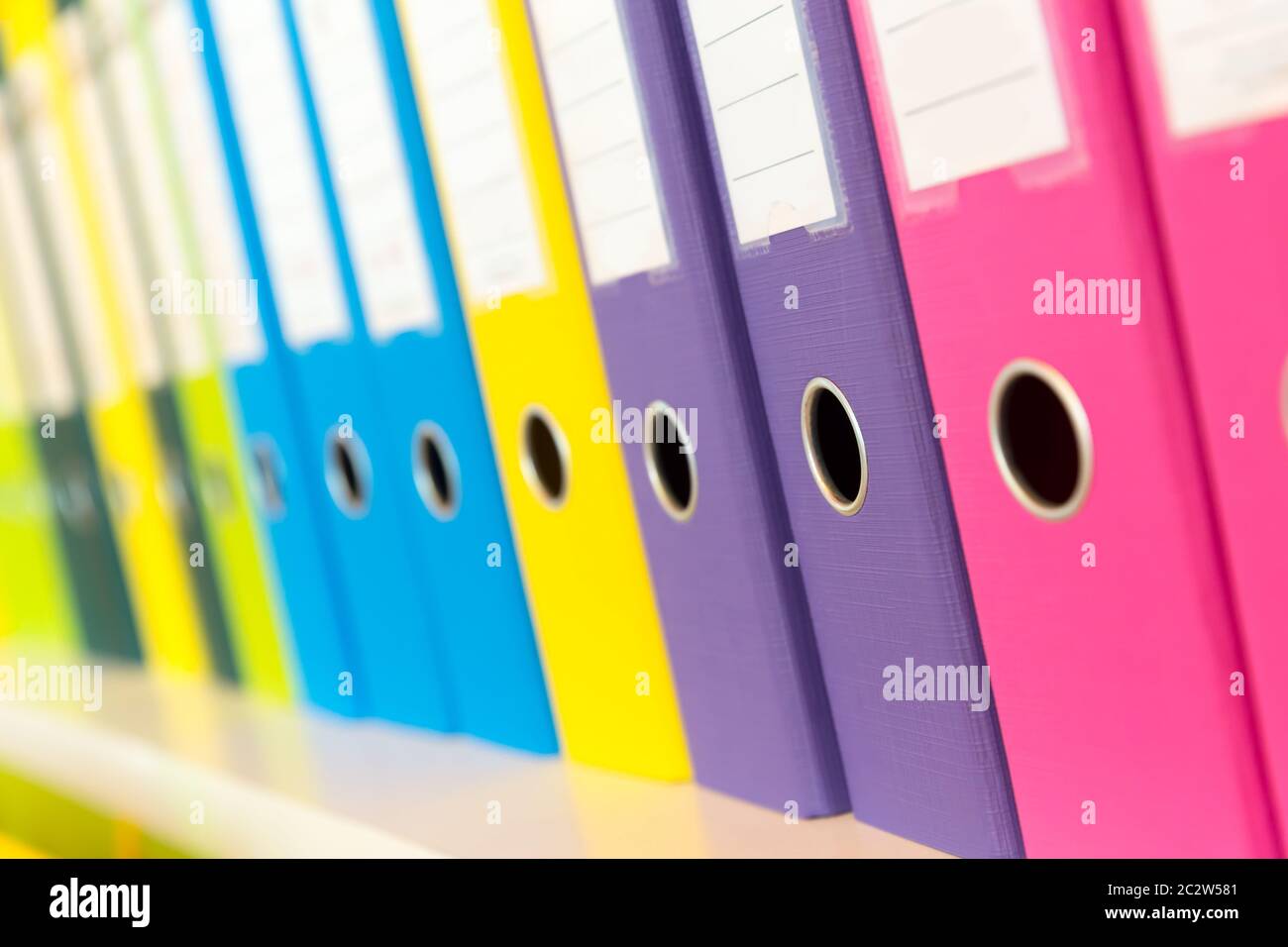 Colorful folders standing on the shelf in the office Stock Photo - Alamy