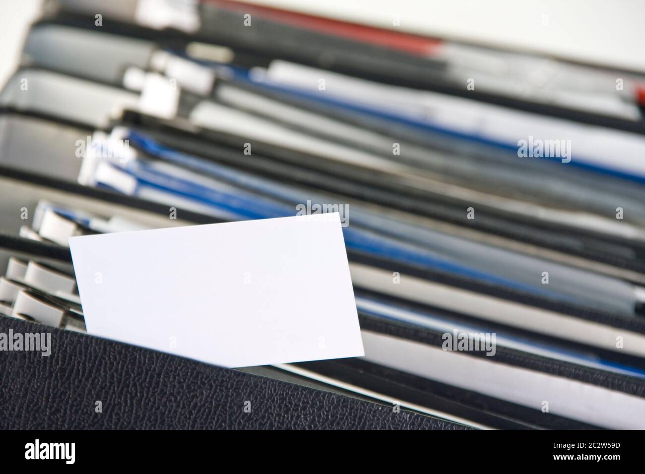 Blank card on stack of binders Stock Photo - Alamy