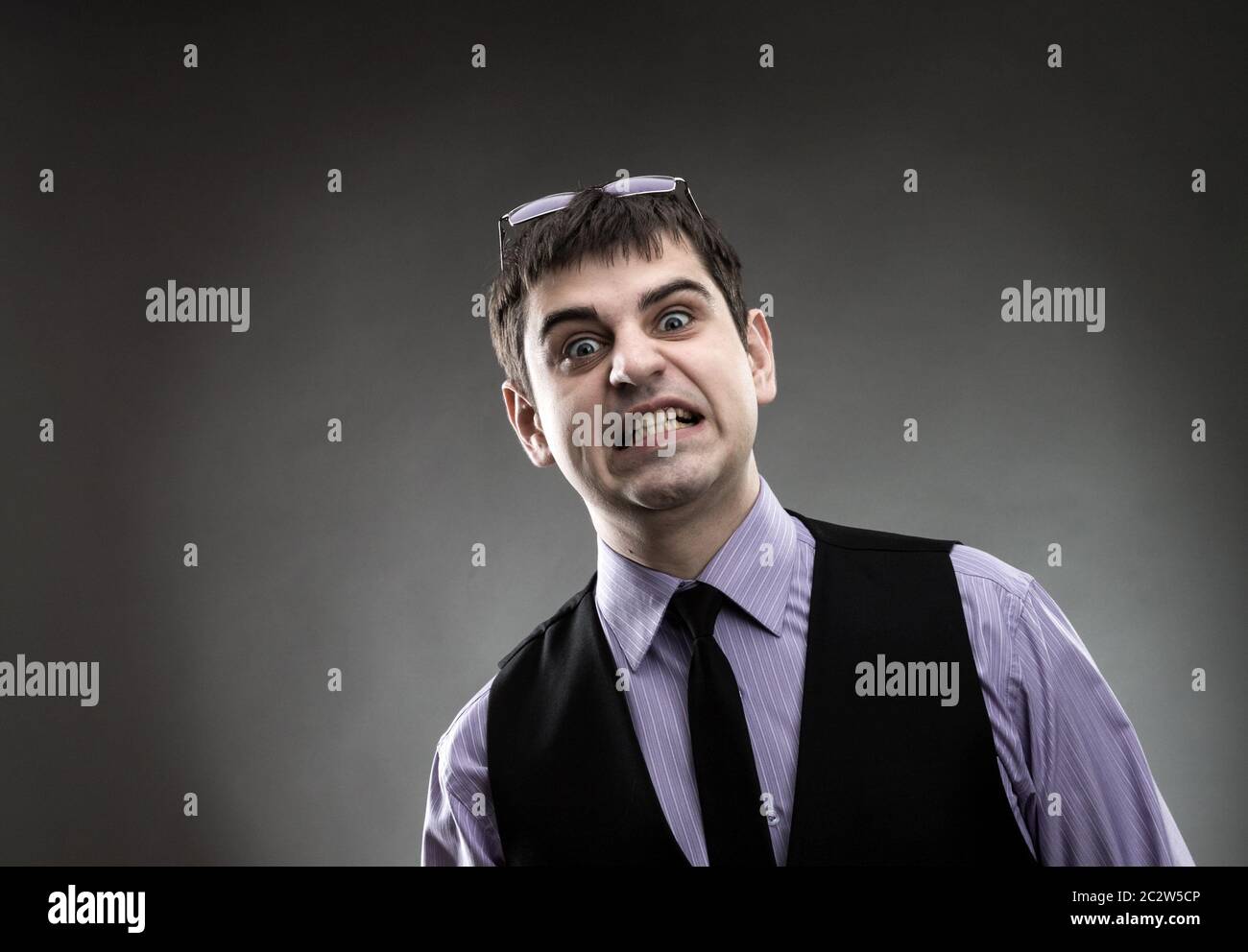 Man weared suit making faces Stock Photo - Alamy