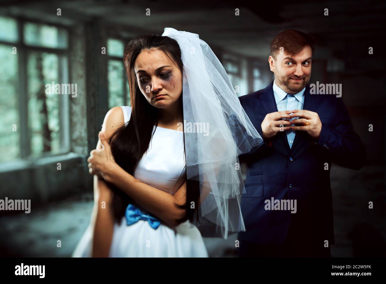 Bride with tearful face, groom with sly smile on background. Unhappy ...