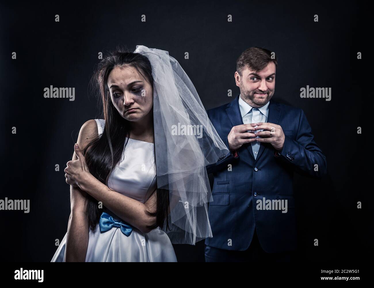 Bride with tearful face, groom with sly smile on background. Unhappy ...