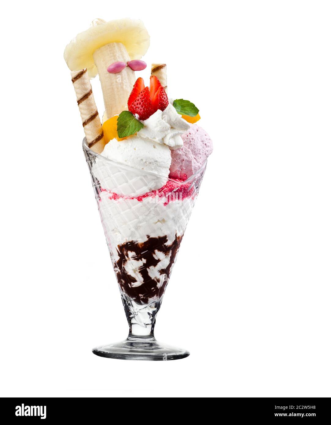 Big ice cream dessert with fruit and whipped cream on a white ...