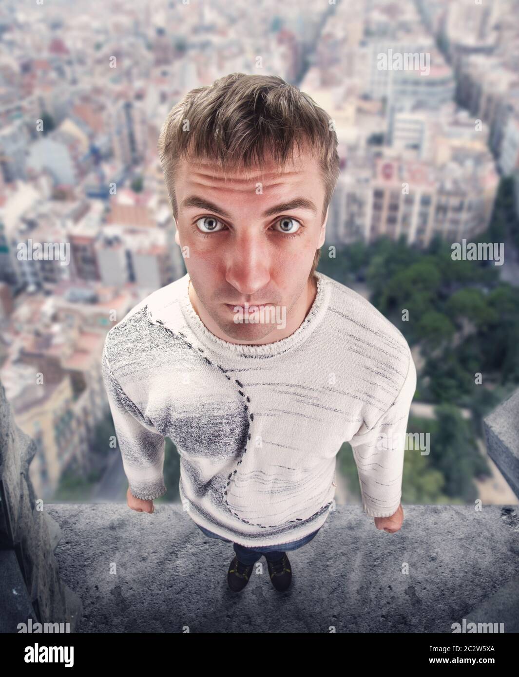 Funny man standing on the edge of the building Stock Photo - Alamy