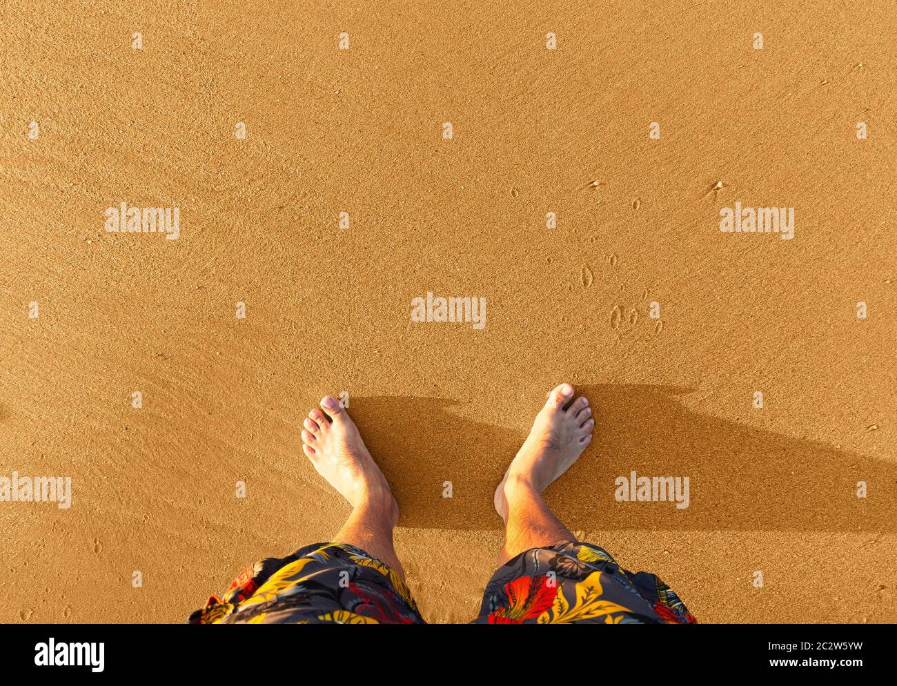 Legs on the sand from above Stock Photo - Alamy