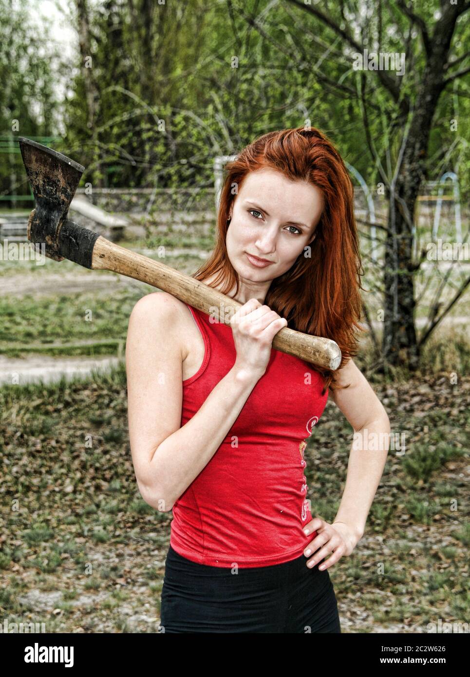 Portrait of young woman with axe Stock Photo - Alamy