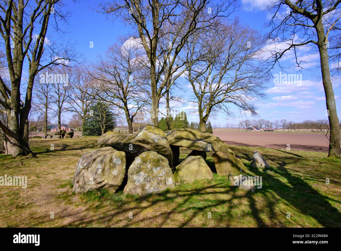 Megalithic dolmen graves in dutch landscape with fields and farms in ...