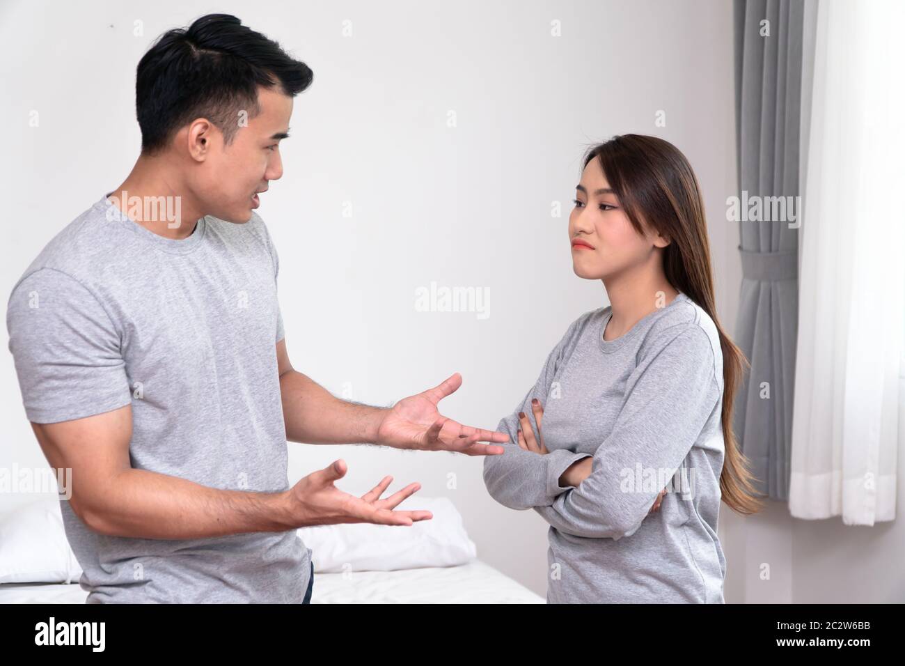 Unhappy Asian Couples Standing Beside Each Other And Women Avoid